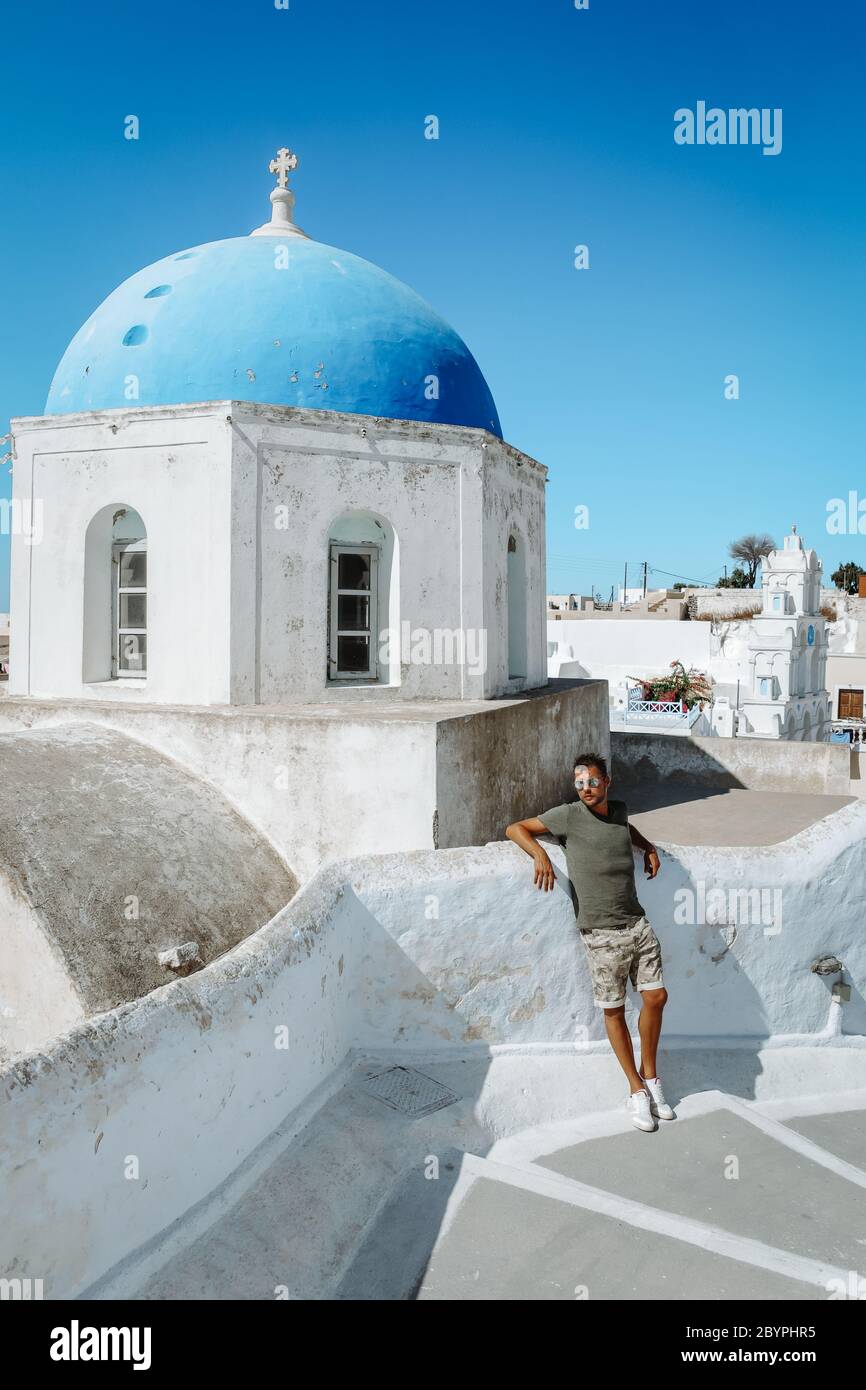 Santorini Greece, young men on vacation at the Island of Greece ...