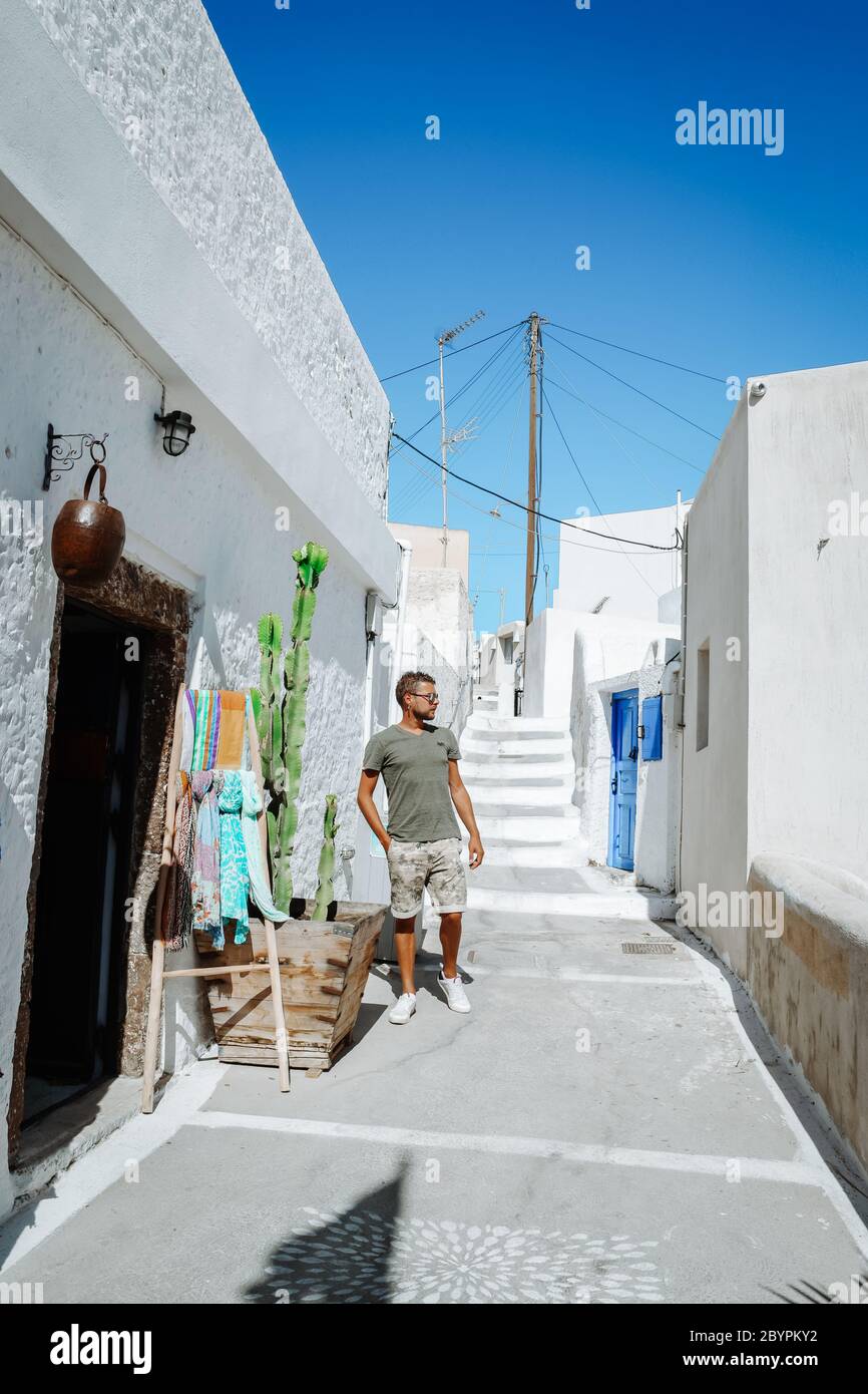 Santorini Greece, young men on vacation at the Island of Greece ...