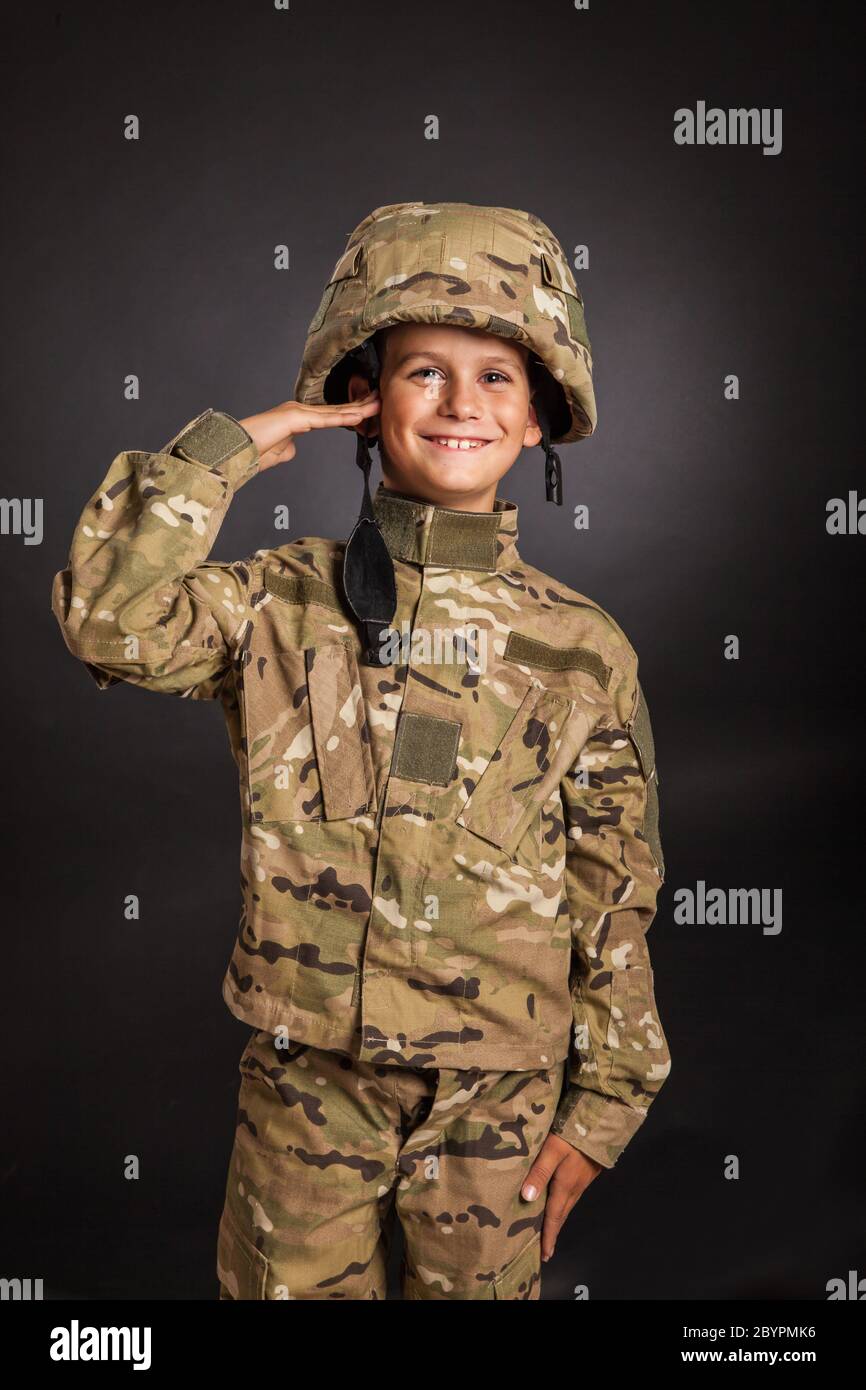 Saluting soldier. Young boy dressed like a soldier Stock Photo - Alamy