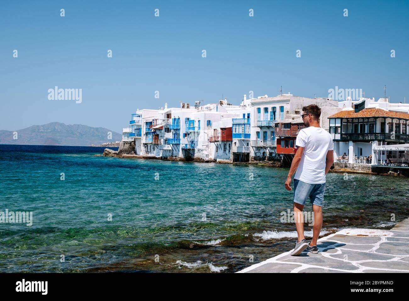 young guy on vacation at the Greek Island of Mykonos, men relaxing at ...