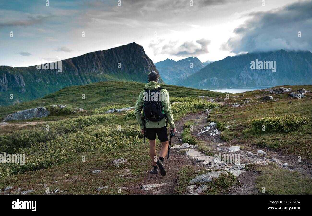Hiker on rocky trail walking on mountain ridge. Concept vision. On top ...