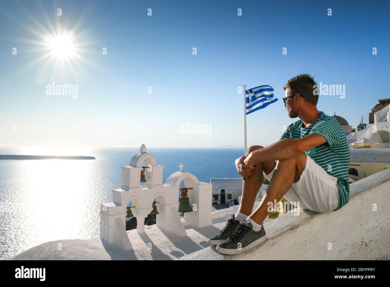 Santorini Greece, young men on vacation at the Island of Greece ...