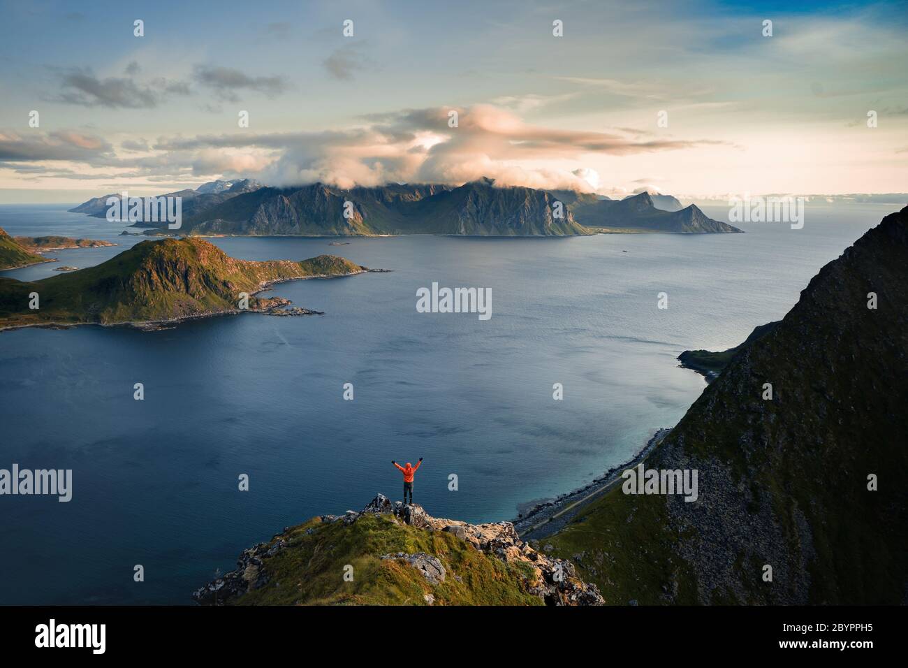 Tourist stand alone on a rock and watching sea horizon within sunset ...