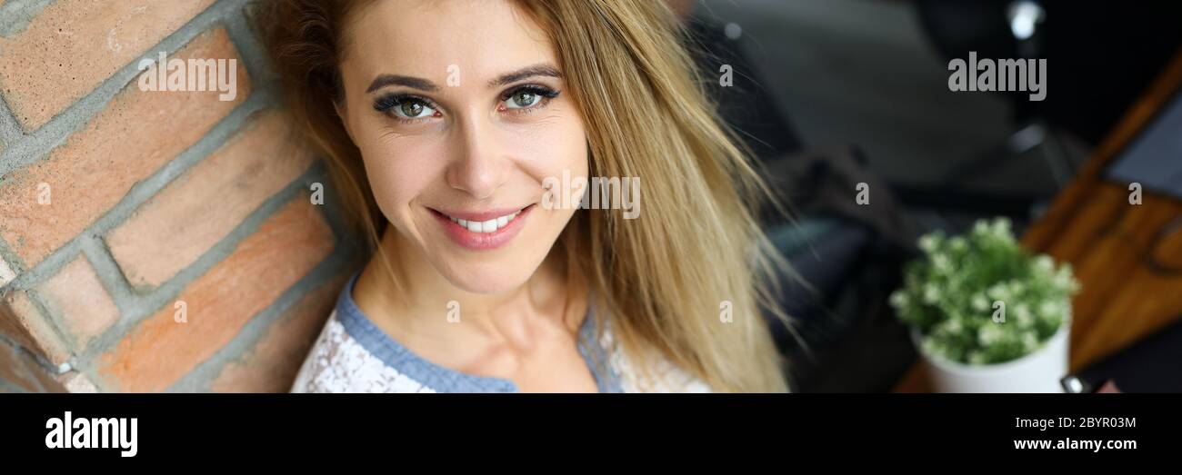 Smiling happy beautiful woman looking at camera Stock Photo - Alamy