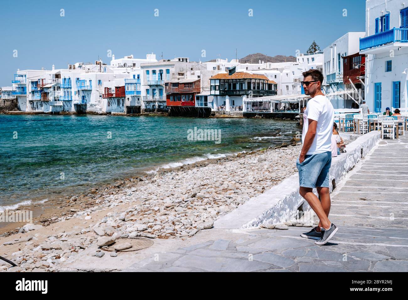 young guy on vacation at the Greek Island of Mykonos, men relaxing at ...