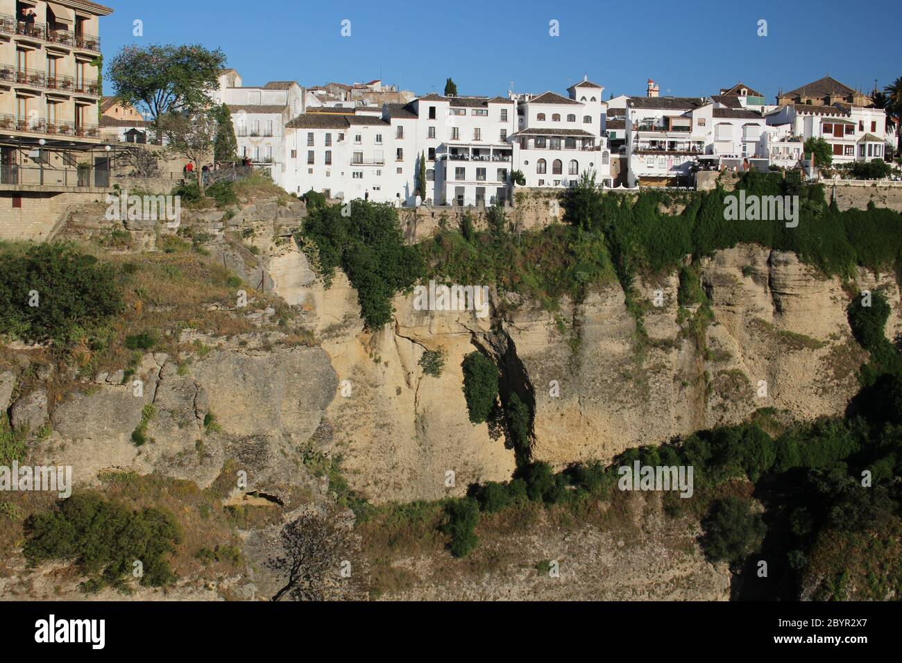 View of cliff top houses in evening sunshine in Ronda Andalusia Spain ...
