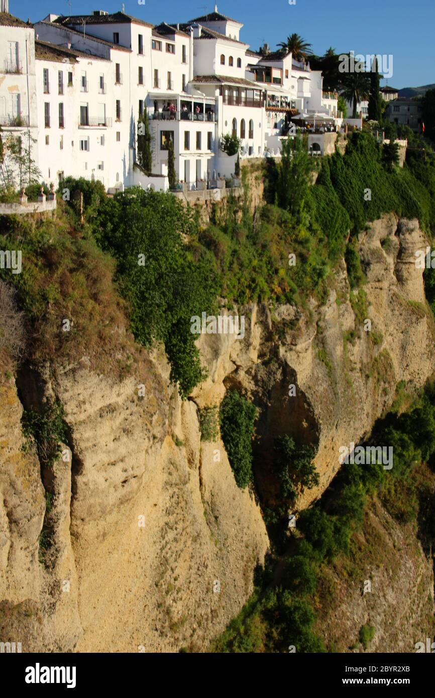 View of cliff top houses in evening sunshine in Ronda Andalusia Spain ...
