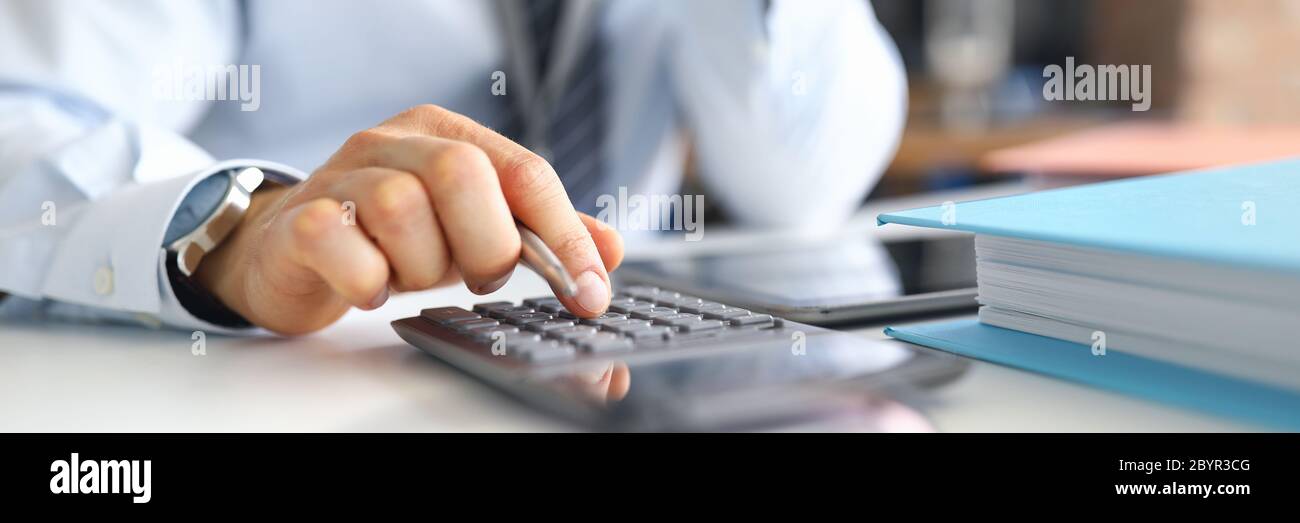 Hand of male businessperson making calculations Stock Photo - Alamy