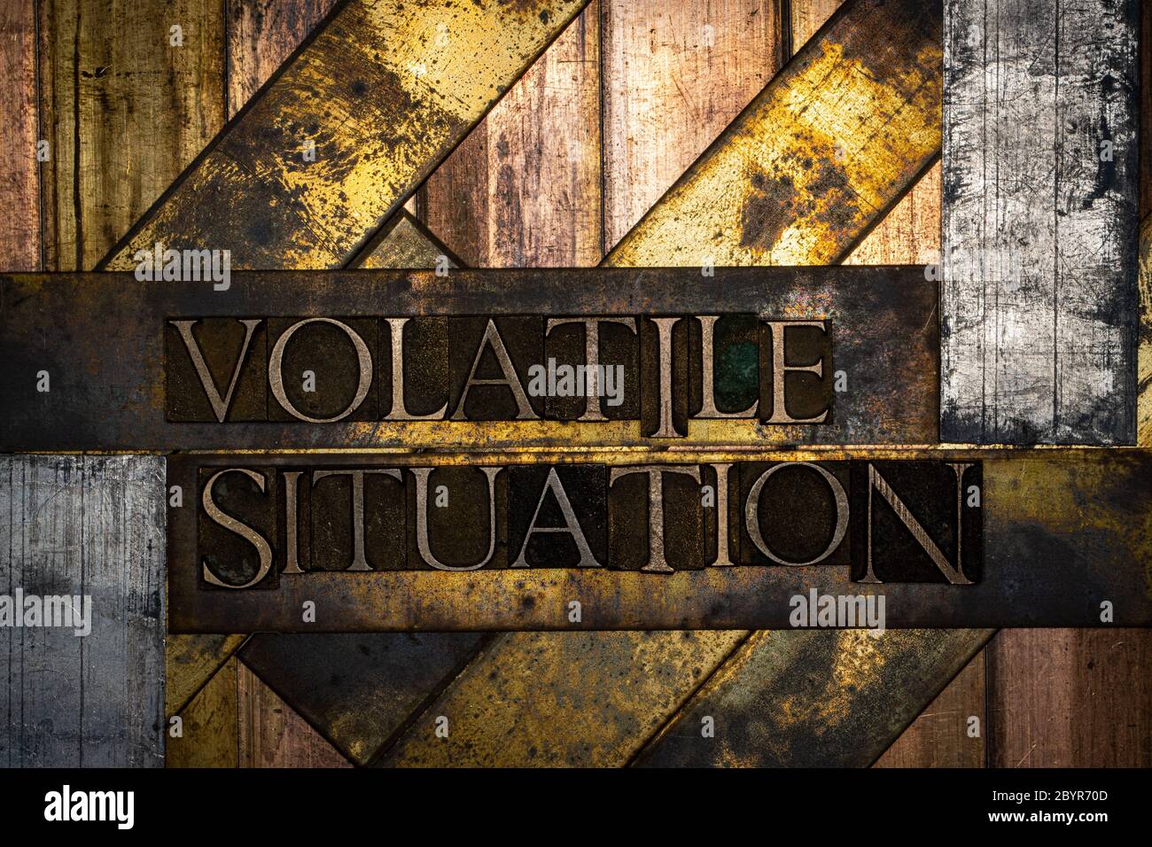 Photo of real authentic typeset letters forming text Volatile Situation ...
