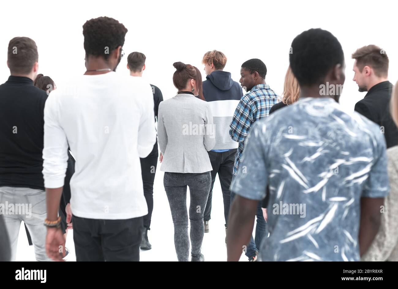 a group of young people stand with their backs looking into the ...