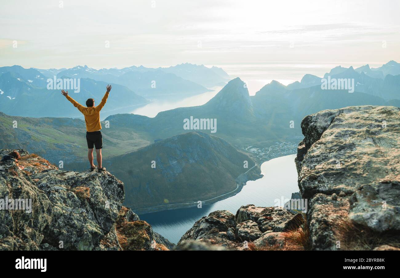 Successful man screaming with happiness on a mountain peak. Achieving ...