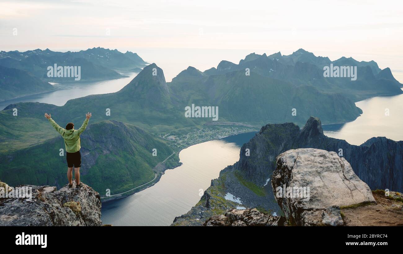 Successful man screaming with happiness on a mountain peak. Achieving ...