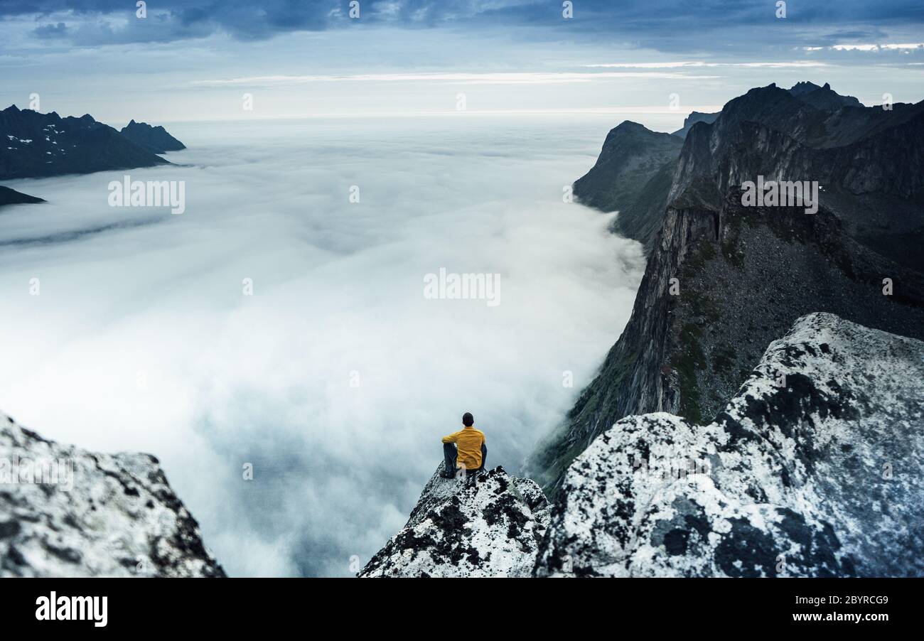 Life on the edge. Traveler on a cliff above a fjord enjoying Norway. Landscape travel lifestyle ...