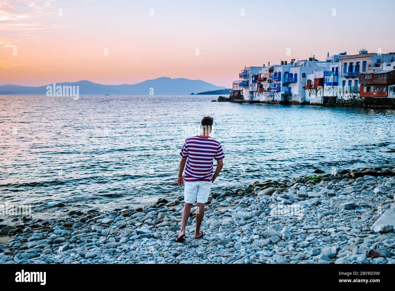 young guy on vacation at the Greek Island of Mykonos, men relaxing at ...