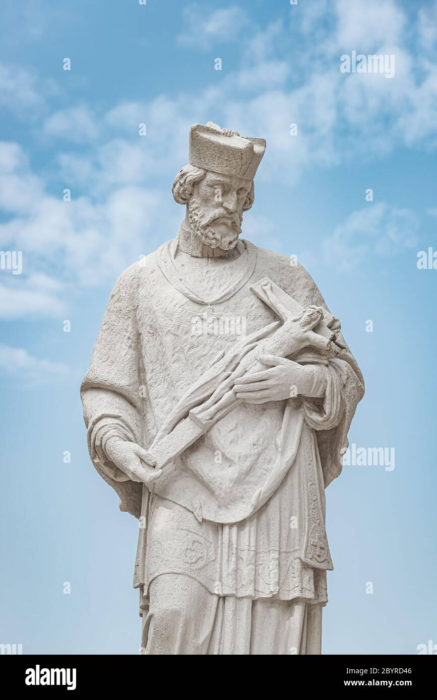 Statue of priest with figure of crucified Jesus in Vienna downtown at ...