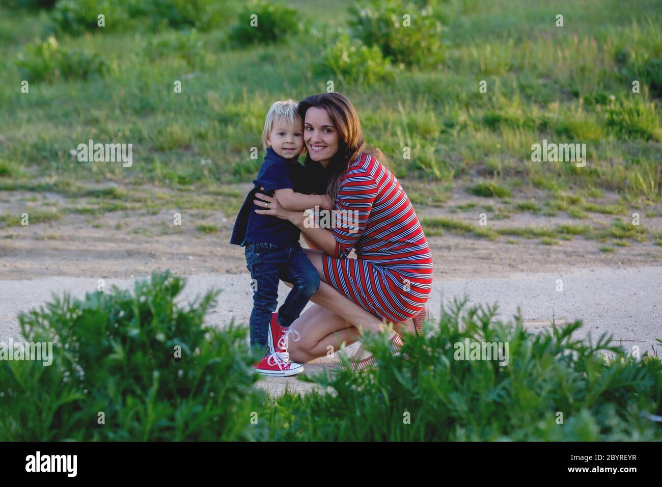 Spring portrait of happy family in nature on sunset, having fun ...