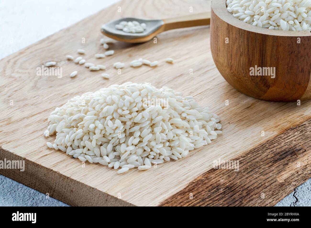 A heap of dry risotto rice on wooden board Stock Photo - Alamy