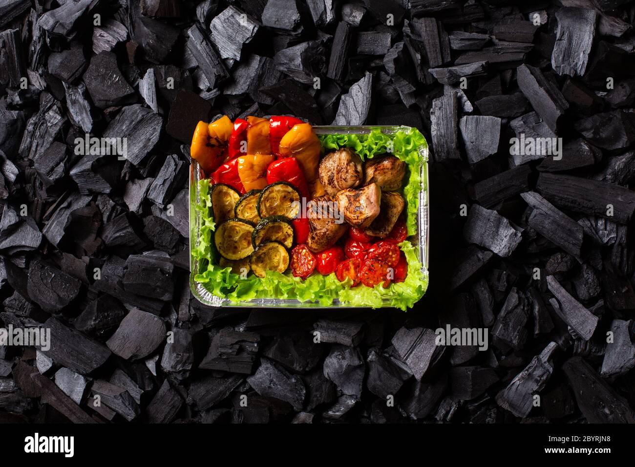 Ready shish kebab. Portion of grilled meat and vegetables in a ...