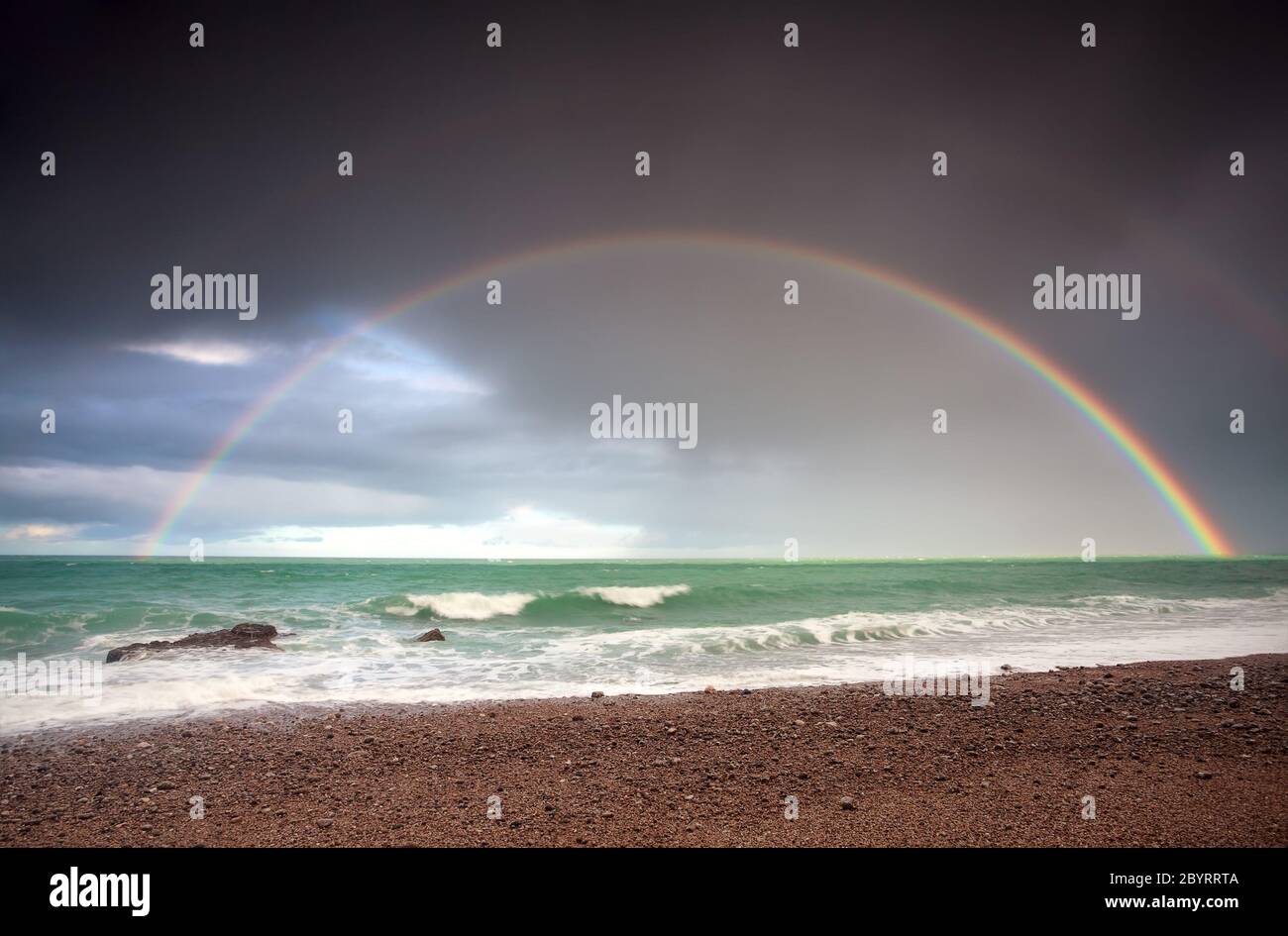 double rainbow over ocean coast Stock Photo - Alamy