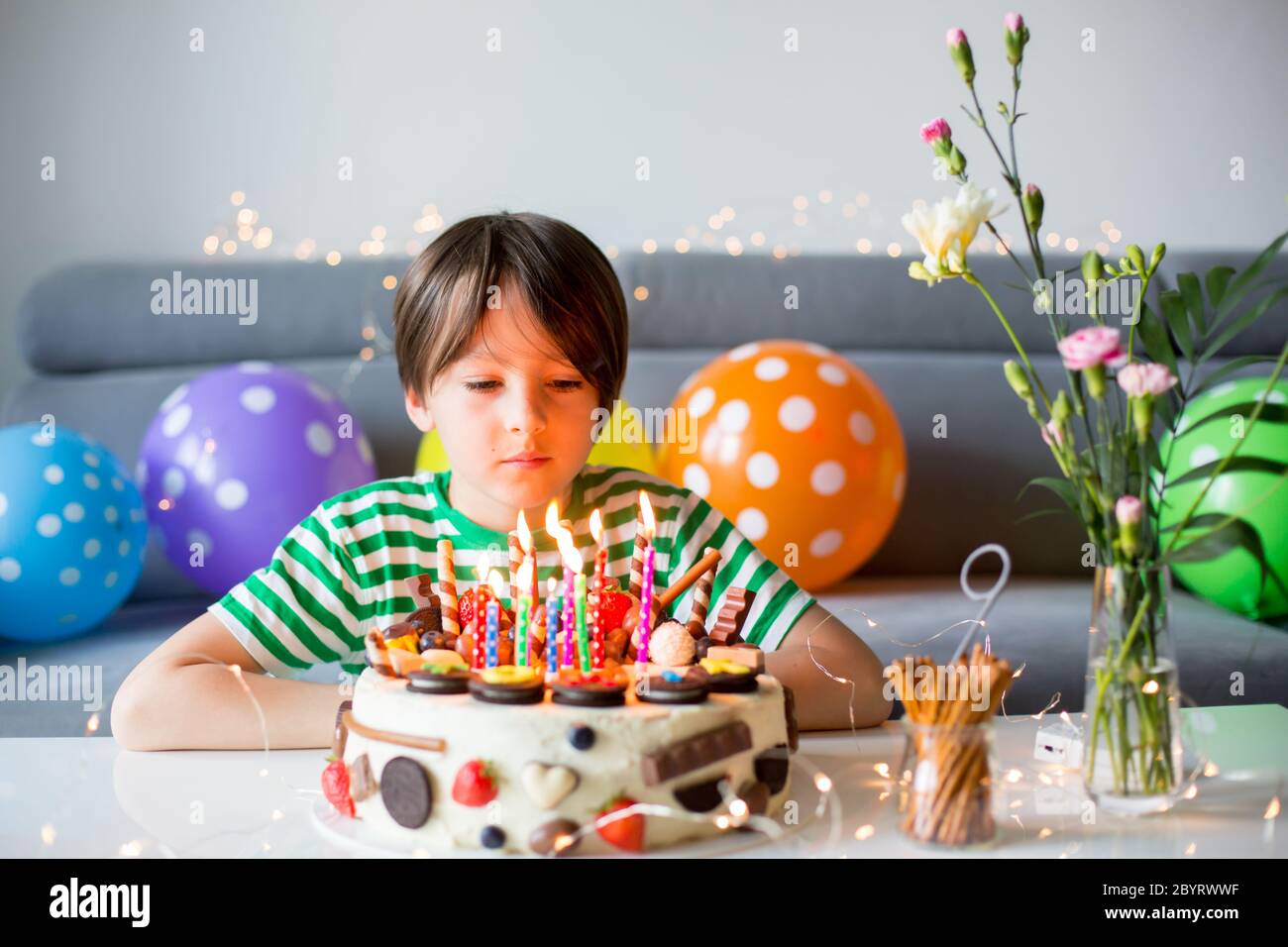 Sweet child, celebrating his birthday with homemade birthday cake with ...