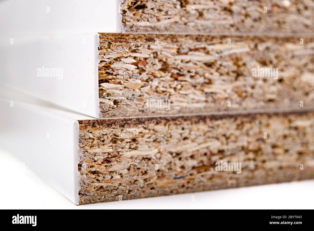 Pieces of white chipboard stacked. Material for the construction of ...