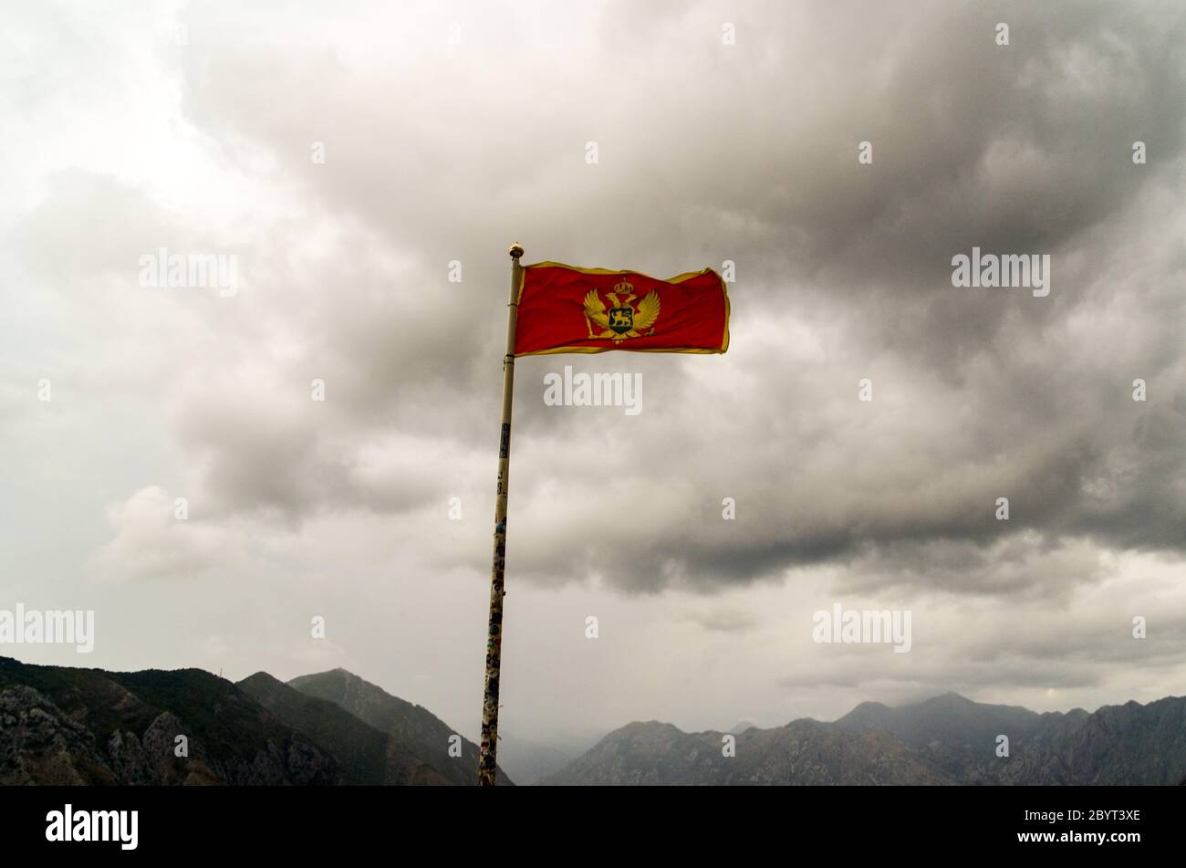 Flag of Montenegro with a cloudy background, Bay of Kotor, Montenegro ...