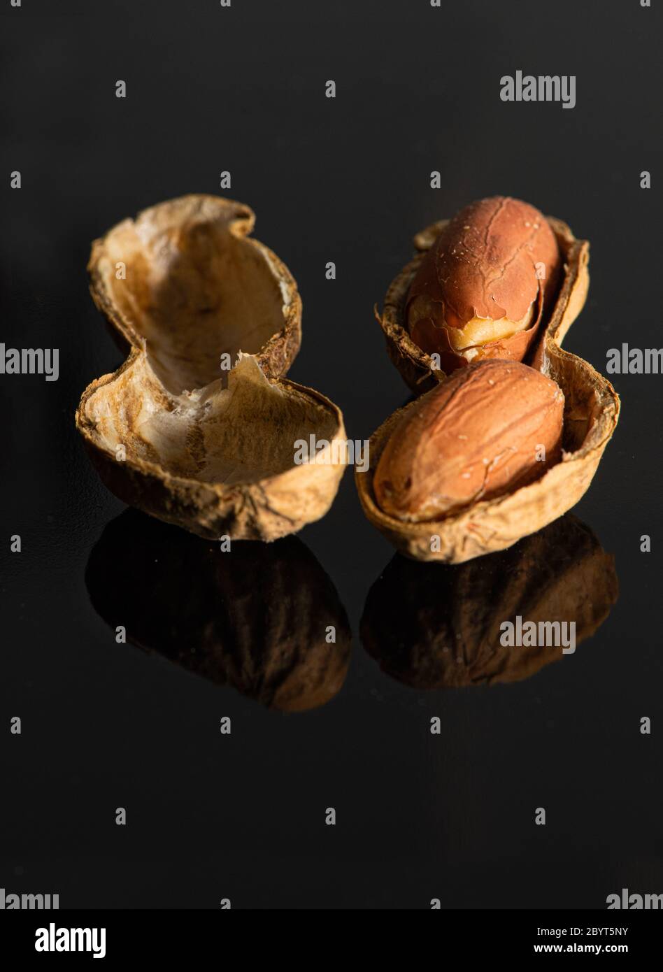 Image of an open peanut, in shell on black background Stock Photo - Alamy