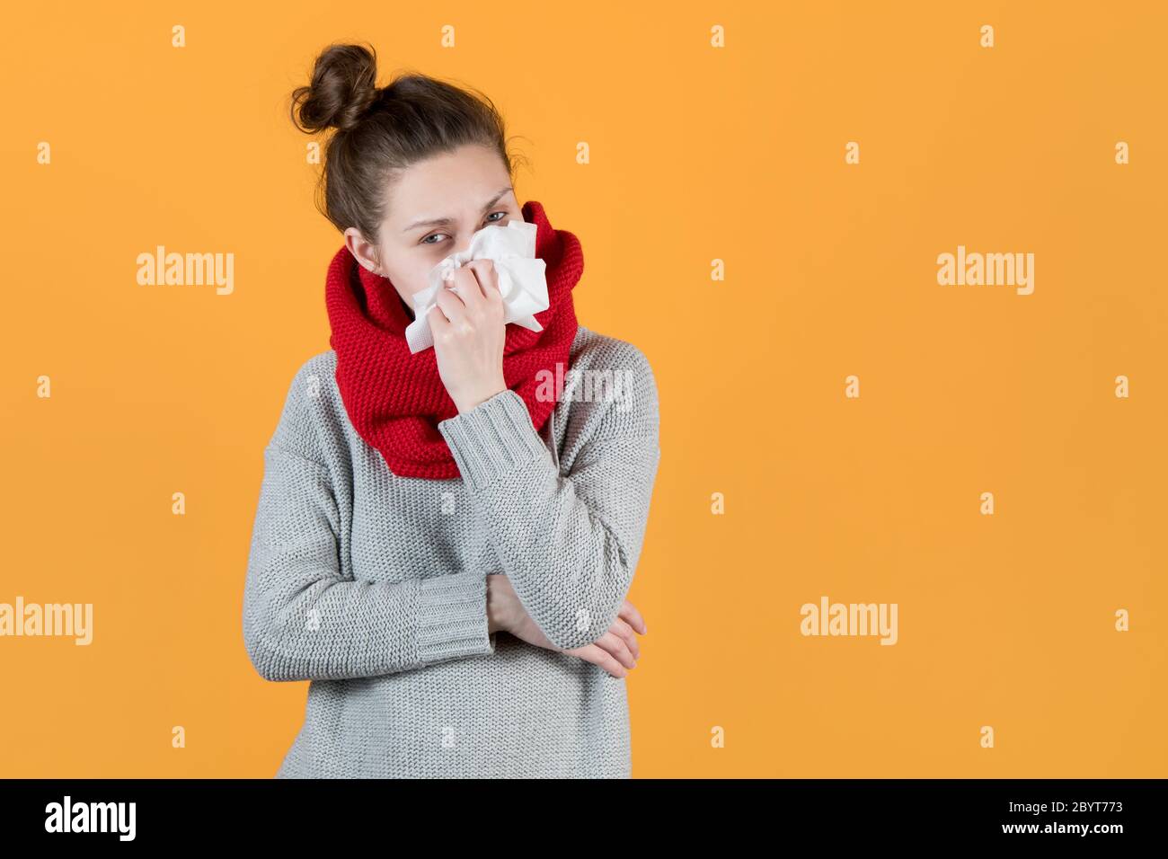 woman of a sickly look holds napkins at her nose, she has a runny nose ...
