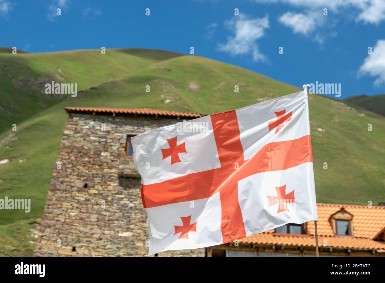Georgian flag waving against blue sky - flag of Georgia, the country ...