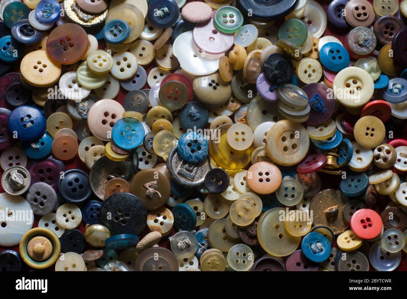 A group of old colored buttons in a textile workshop Stock Photo - Alamy