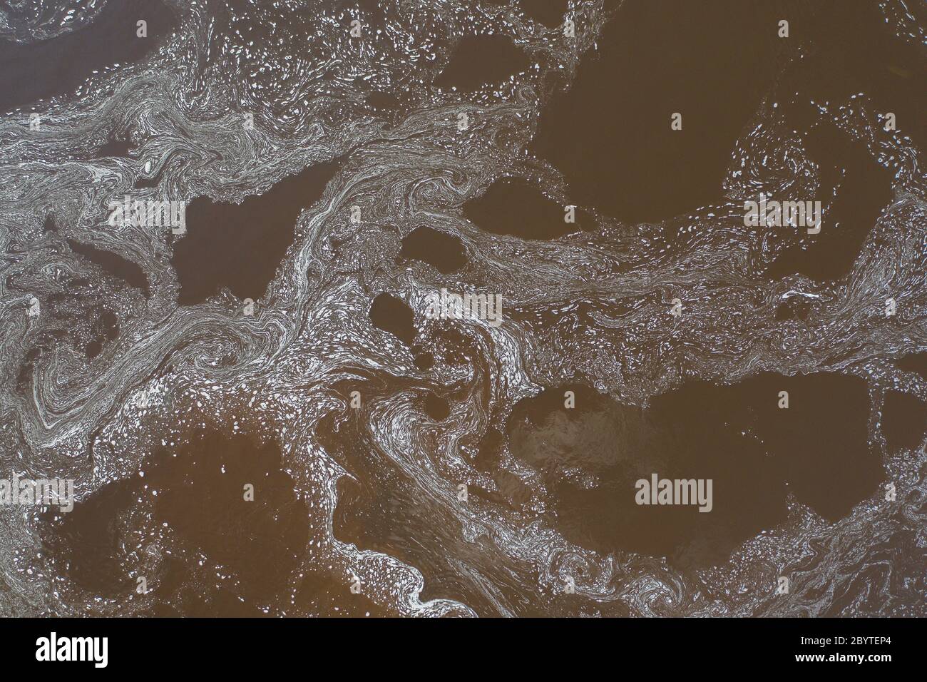 Aerial view of changing patterns of foam on the surface of the water ...