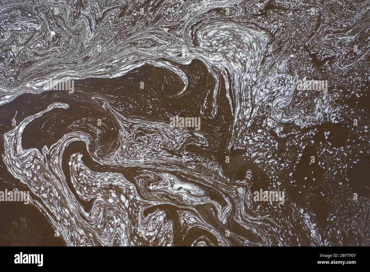 Aerial view of changing patterns of foam on the surface of the water ...