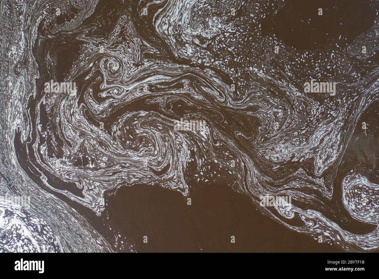 Aerial view of changing patterns of foam on the surface of the water ...