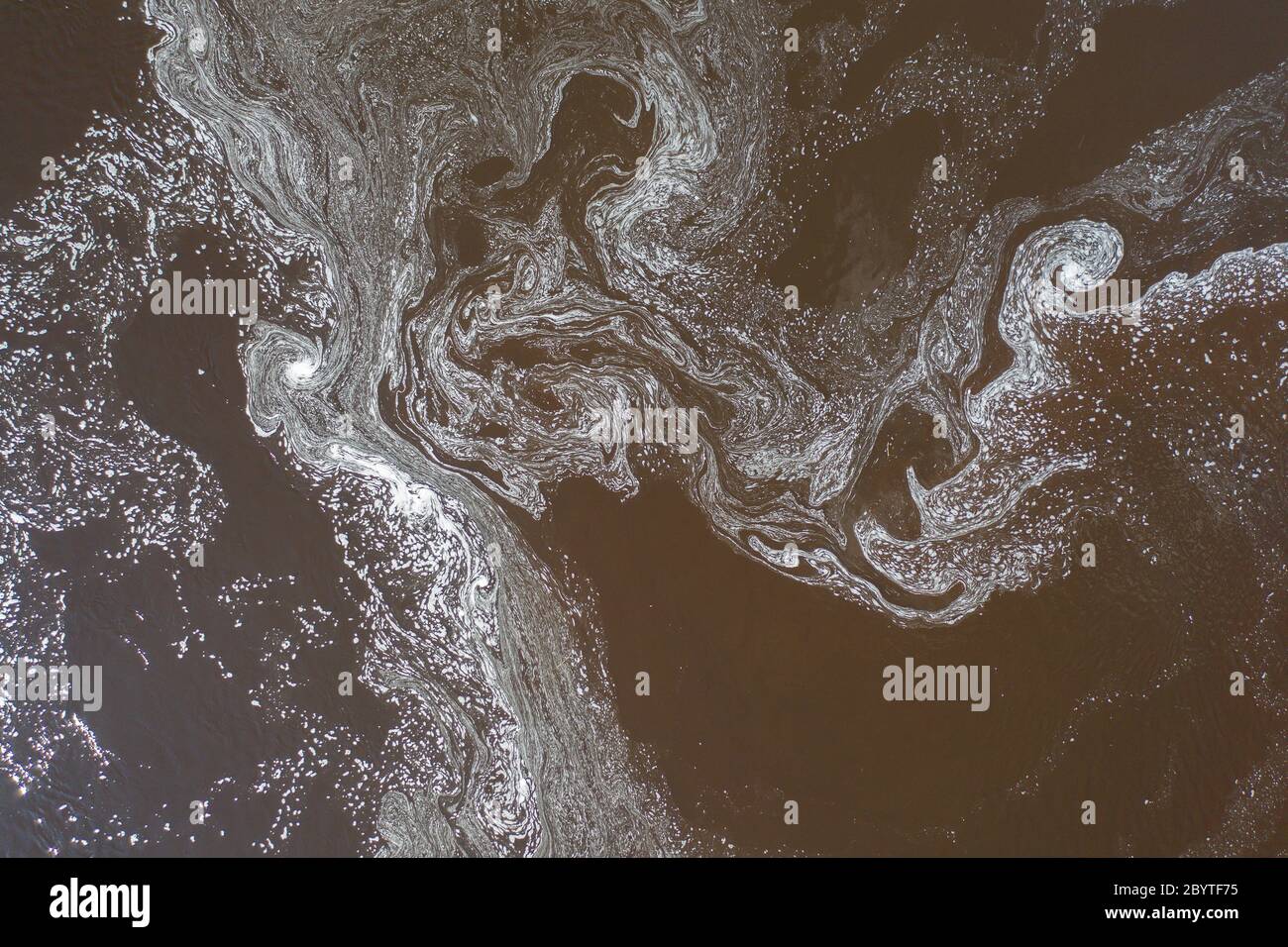 Aerial view of changing patterns of foam on the surface of the water ...