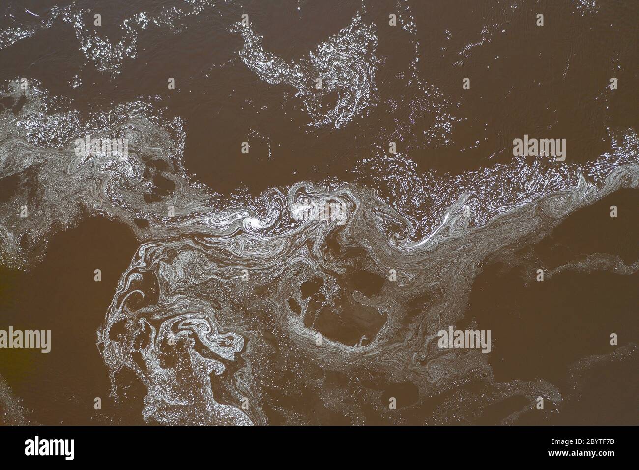 Aerial view of changing patterns of foam on the surface of the water ...