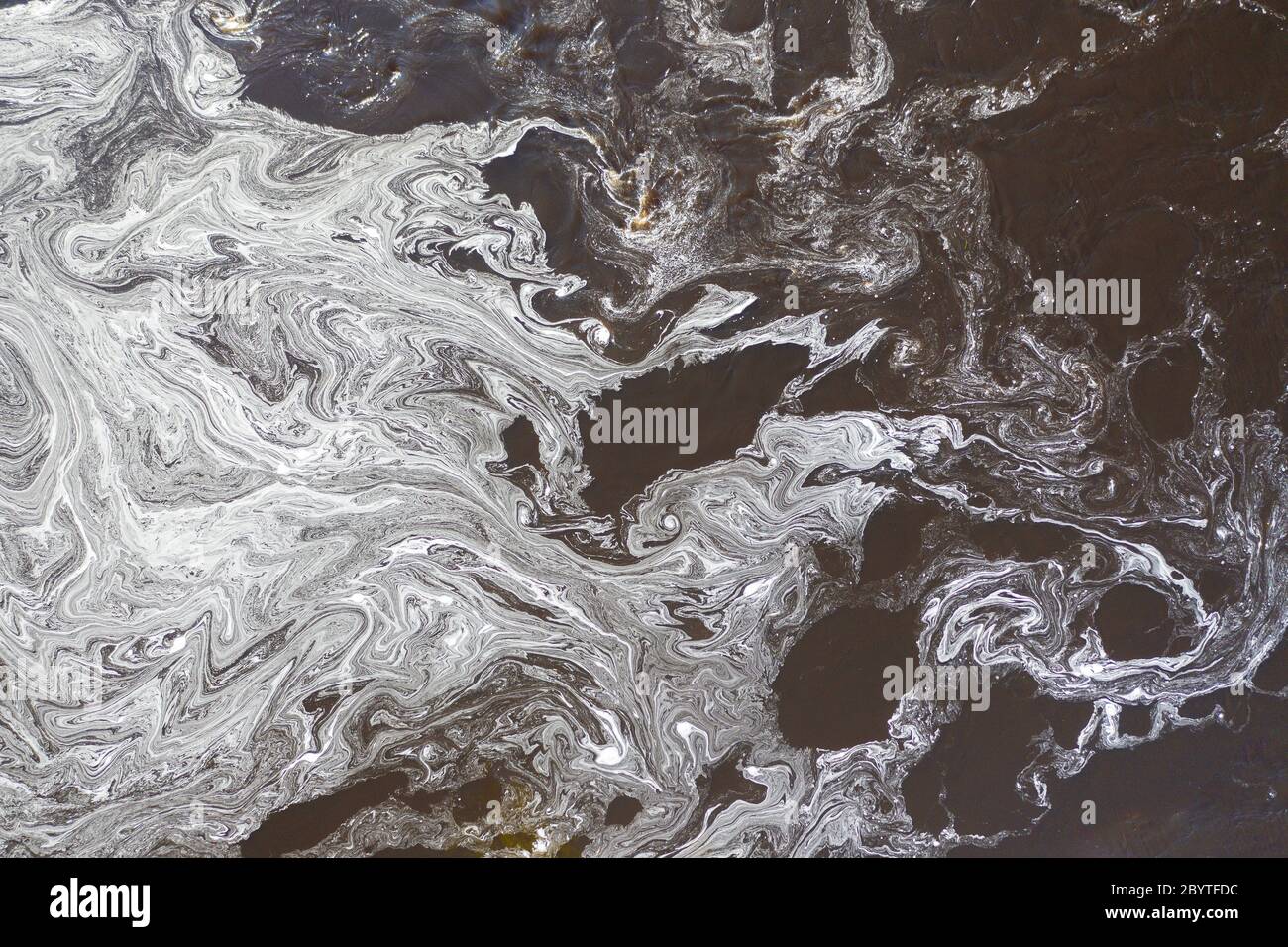 Aerial view of changing patterns of foam on the surface of the water ...