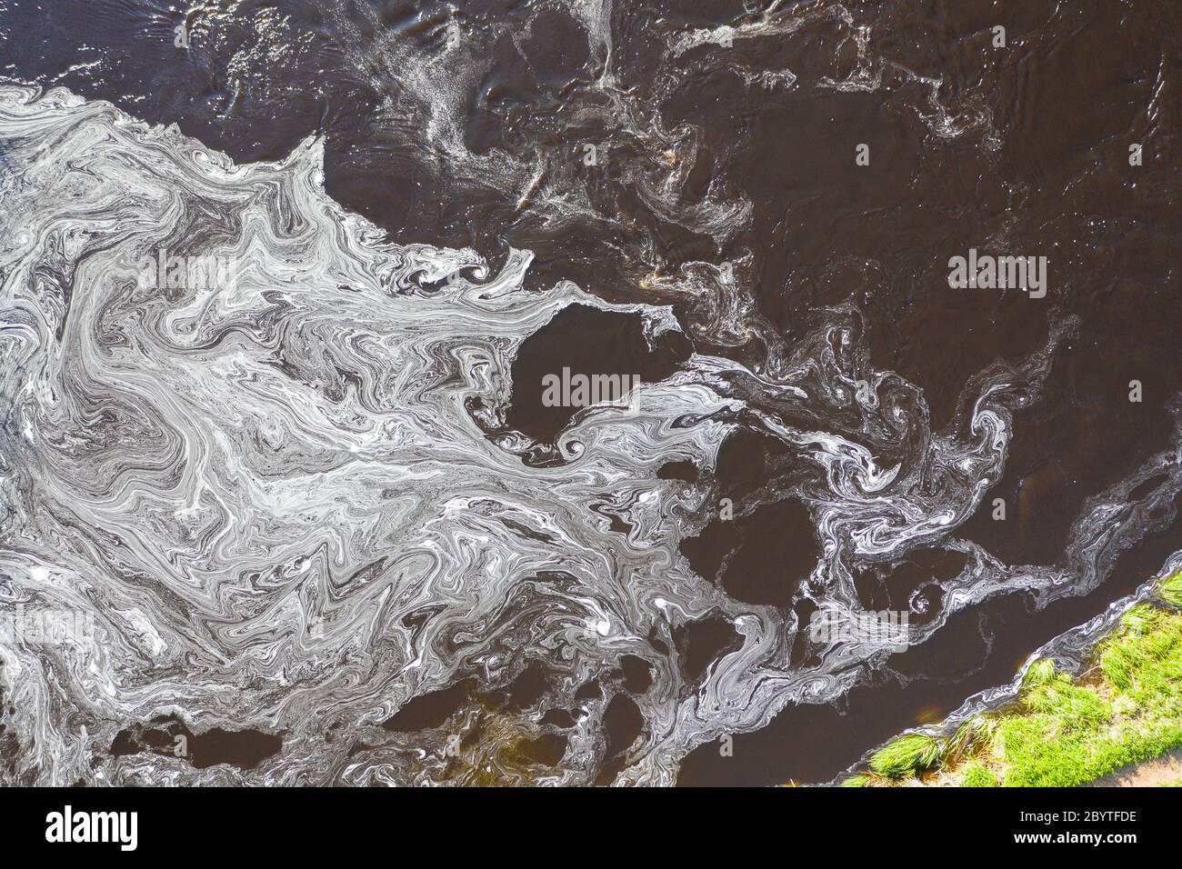 Aerial view of changing patterns of foam on the surface of the water ...