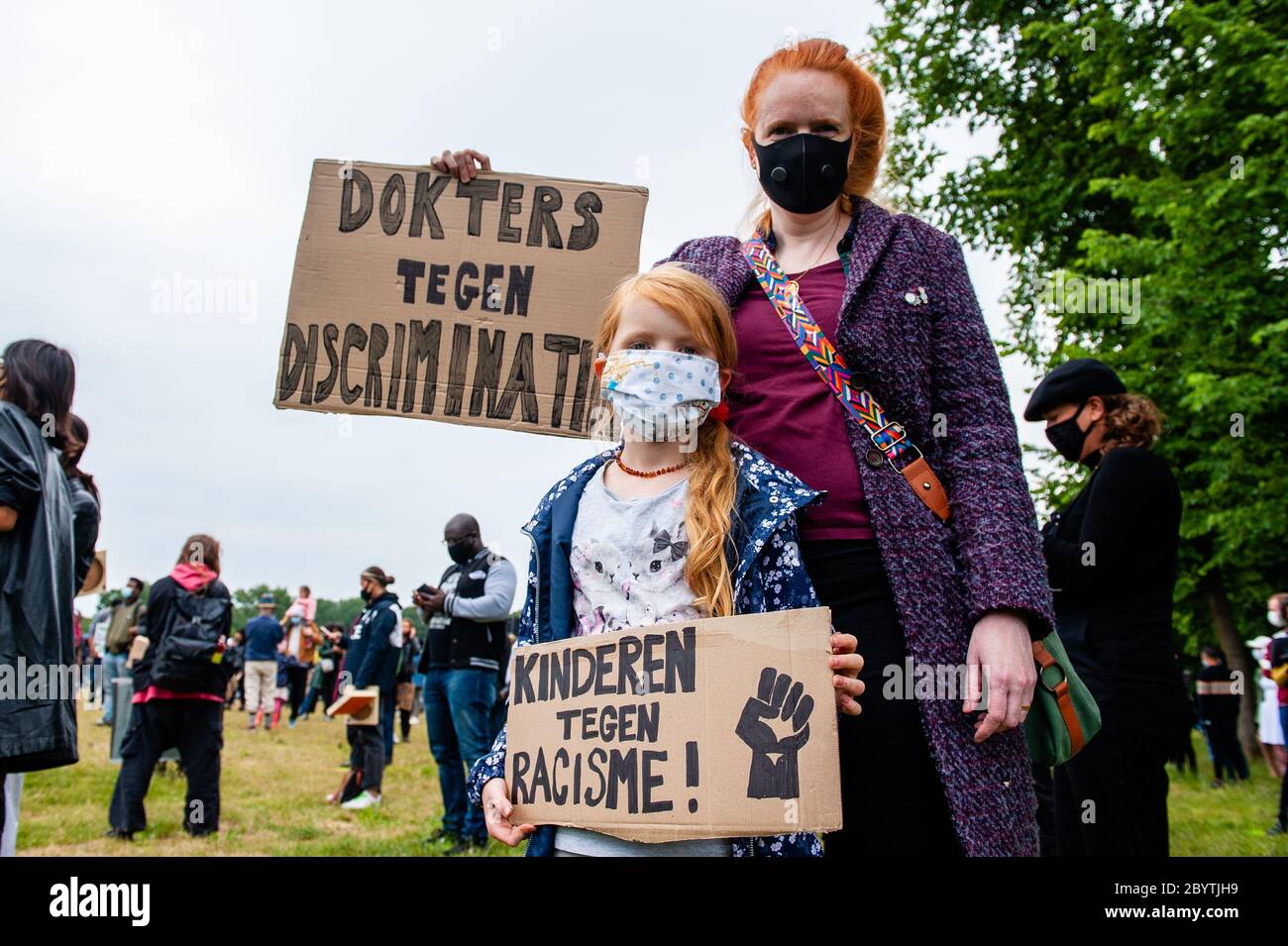 A woman and her daughter holding anti racist placards written in Dutch ...