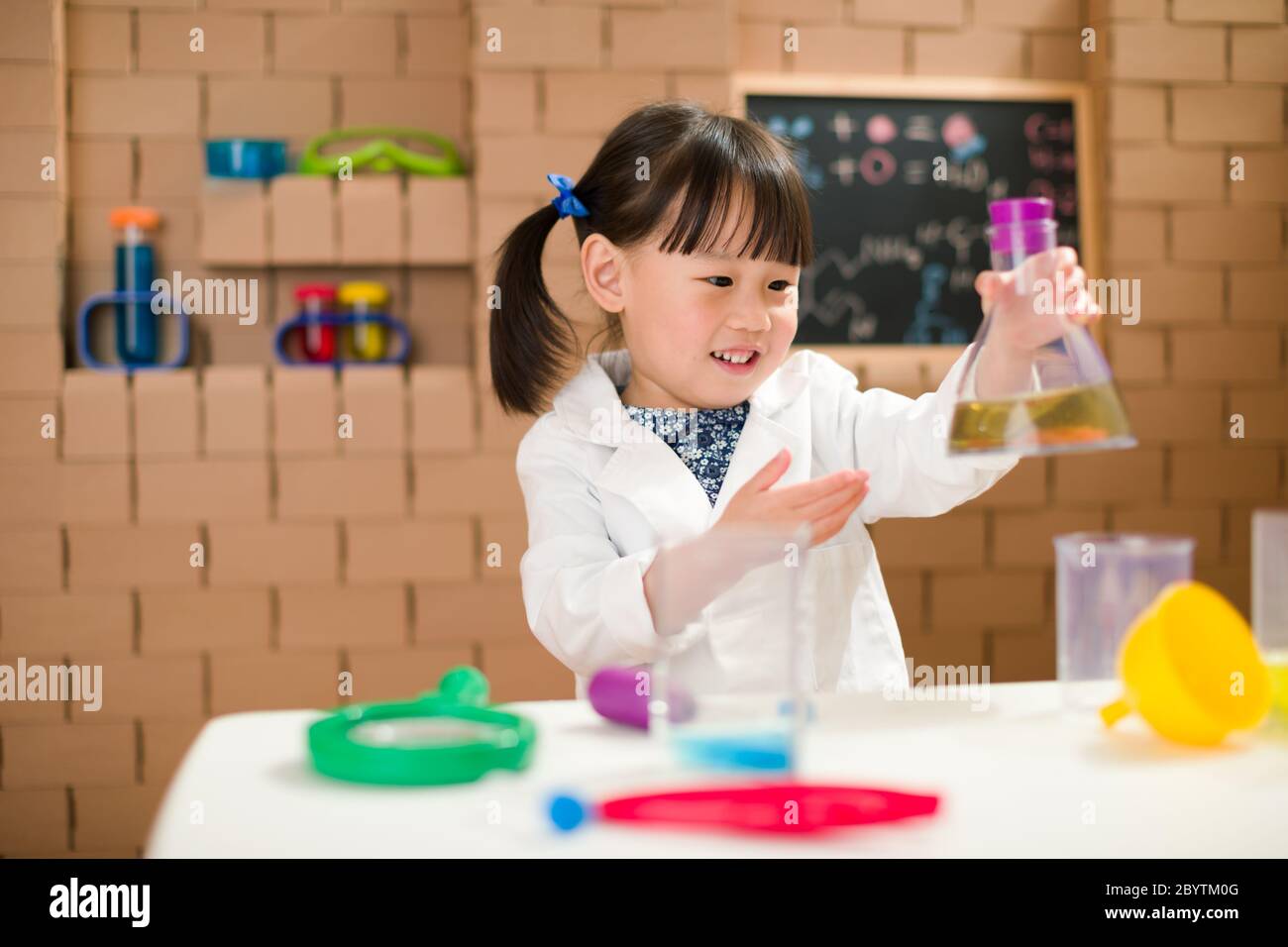 toddler girl pretend play scientist role for homeschooling Stock Photo ...