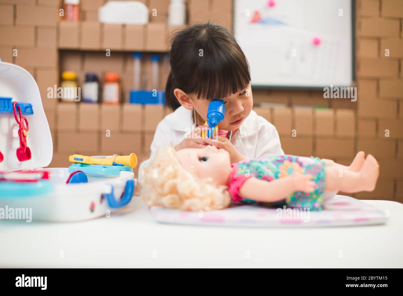 toddler girl pretend play doctor role at home Stock Photo - Alamy