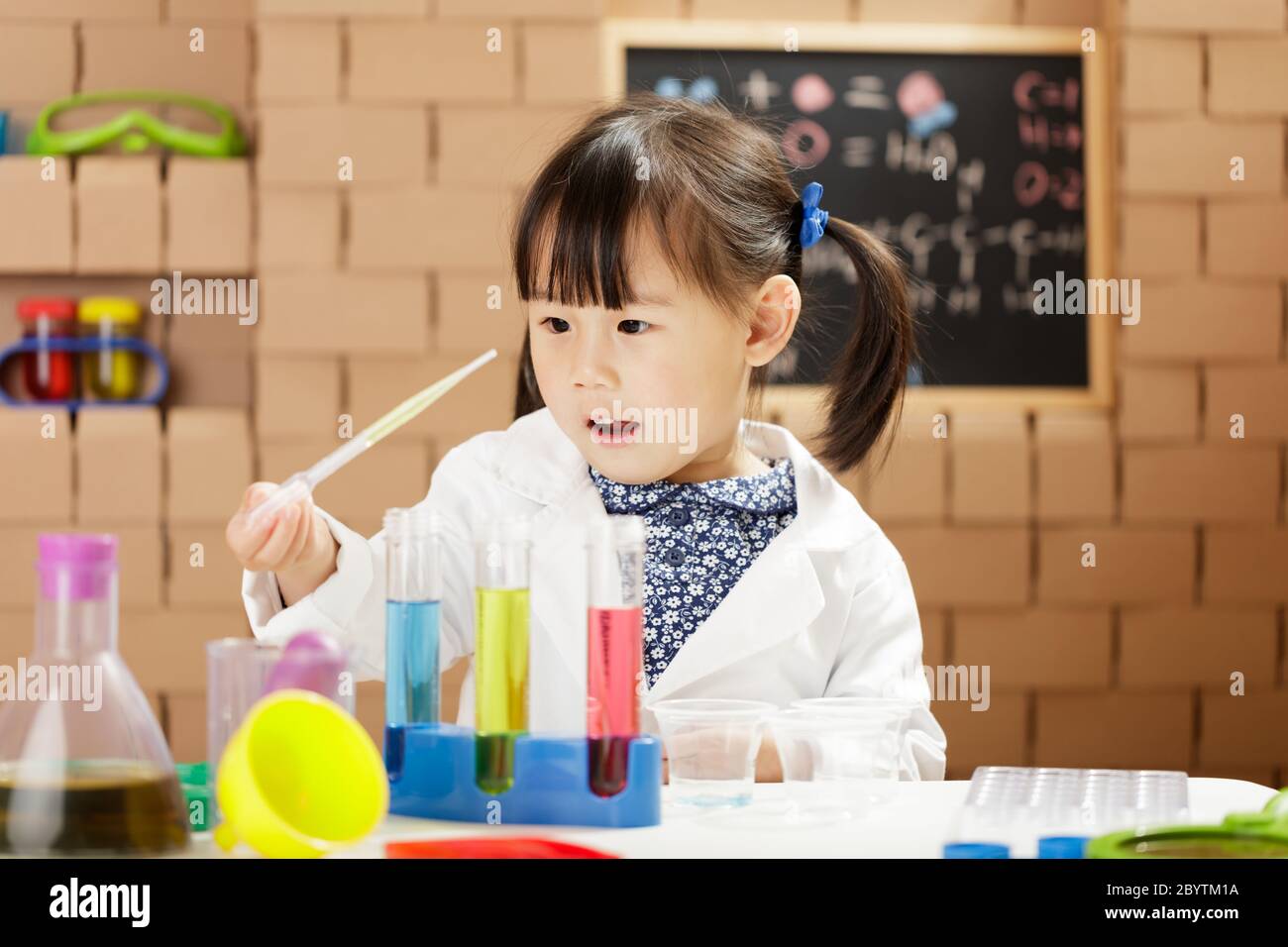 toddler girl pretend play scientist role for homeschooling Stock Photo ...