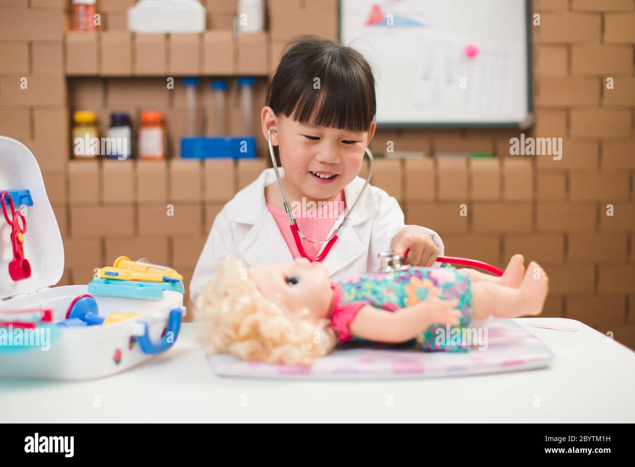 toddler girl pretend play doctor role at home Stock Photo - Alamy