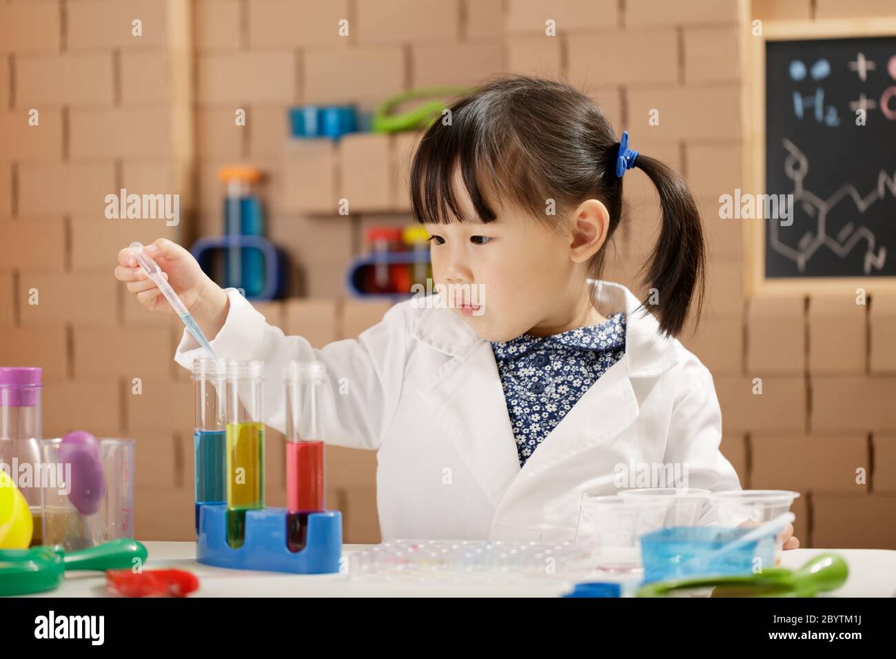 toddler girl pretend play scientist role for homeschooling Stock Photo ...