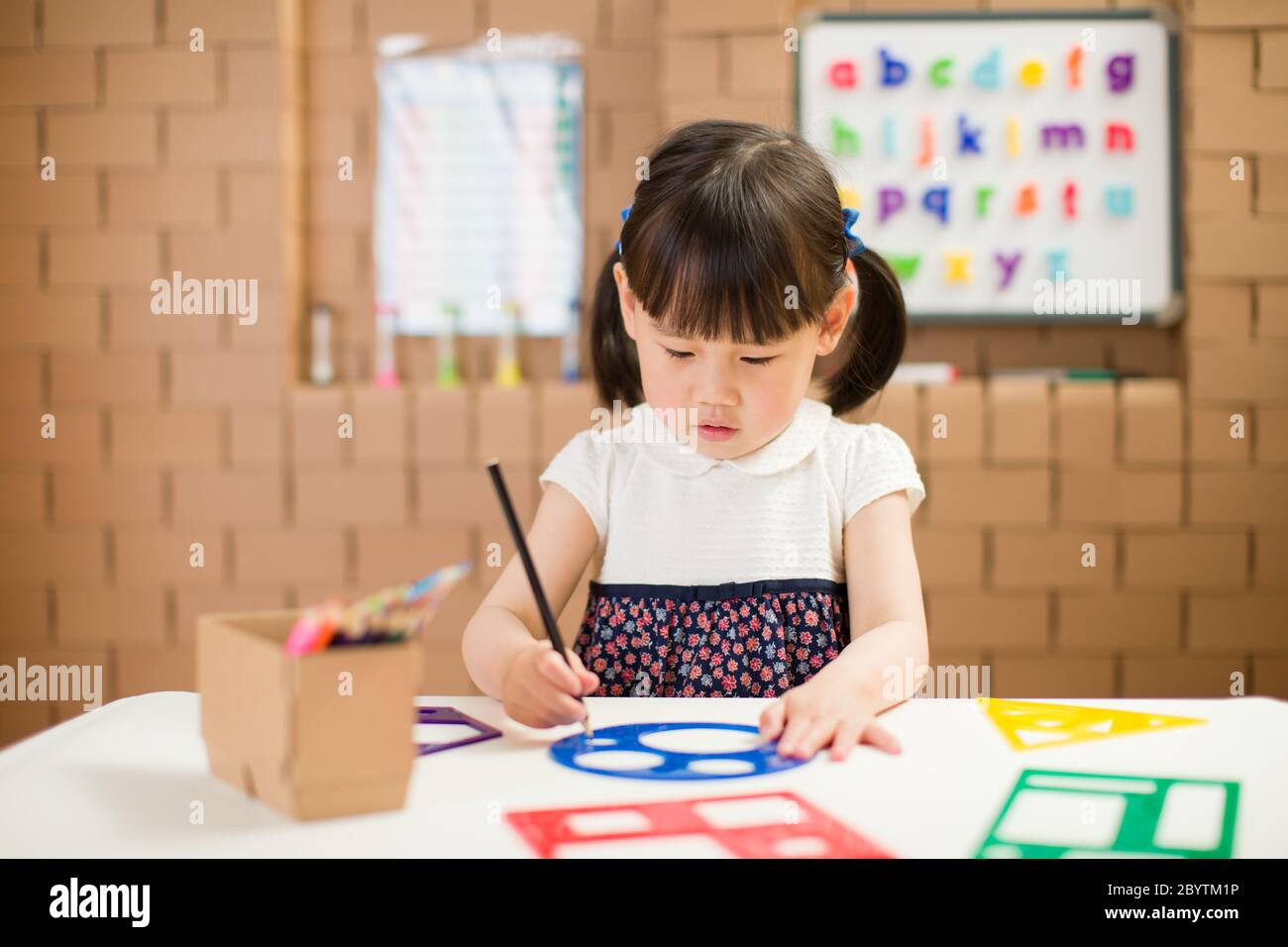 toddler girl practice drawing different shapes for homeschooling Stock ...