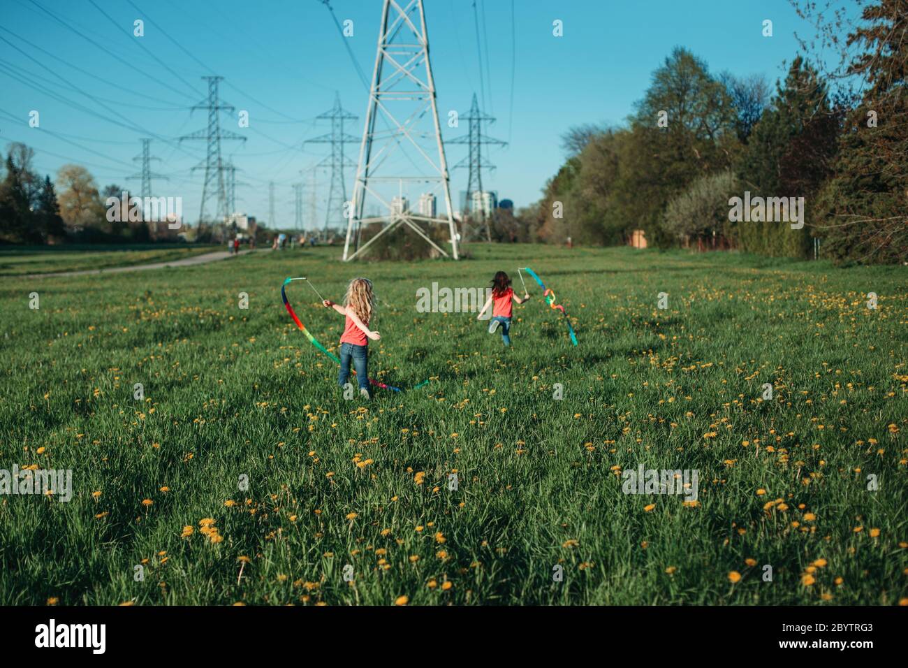 Happy children girls playing with ribbons in park. Cute adorable kids ...