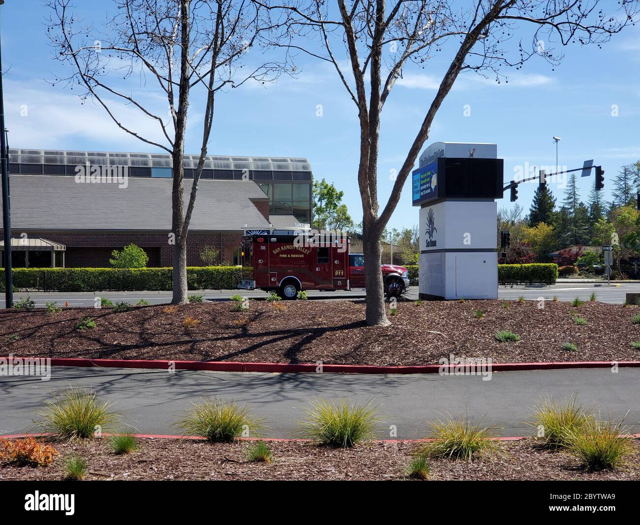 Civic center and announcement sign above bioswale in downtown San Ramon ...