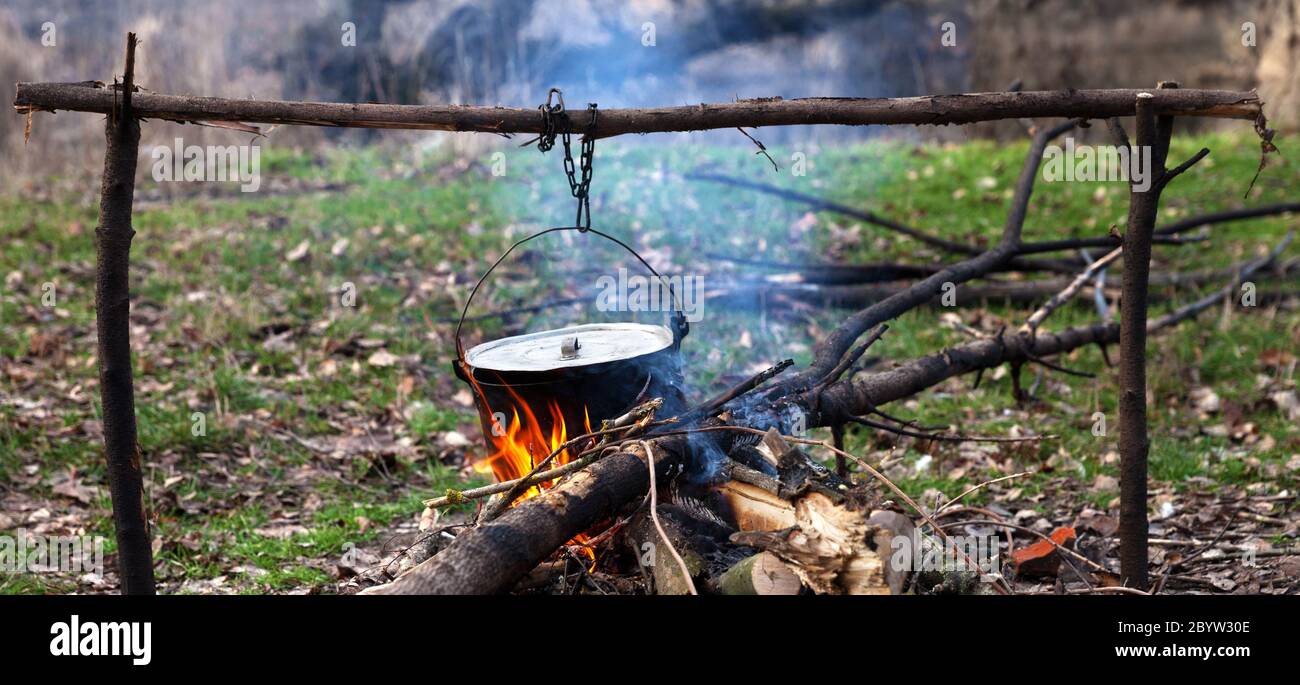Campfire kettle in grass camp hi-res stock photography and images - Alamy