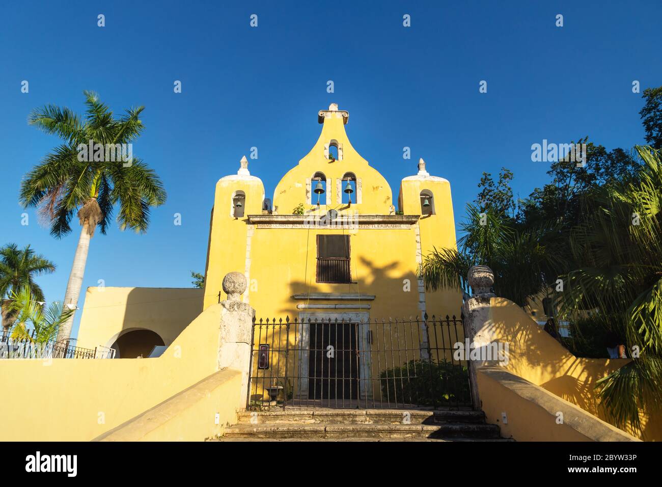 Yellow church with bell tower 'Santa Isabel' in Merida during cloudless ...