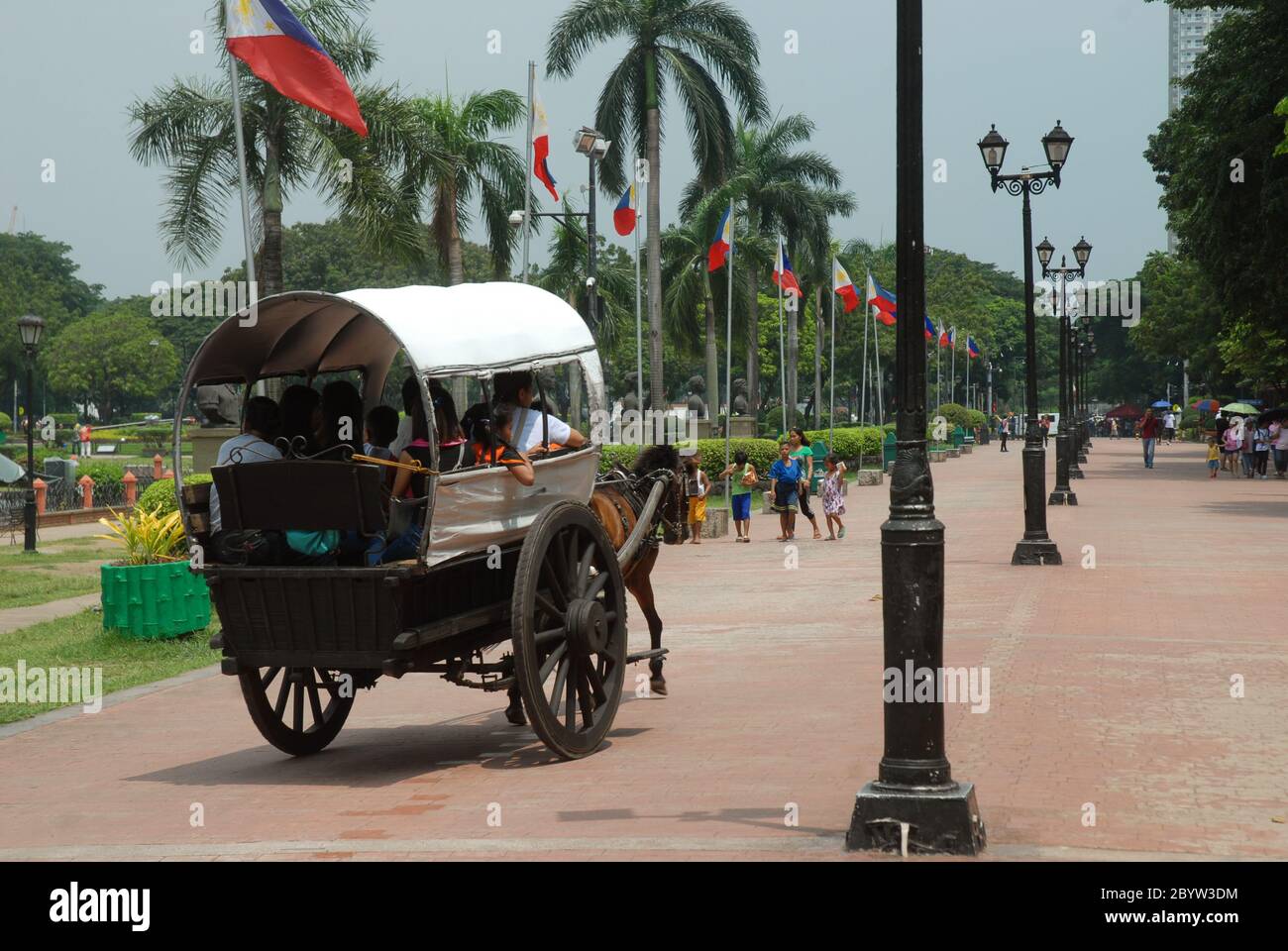 Horse and coach rides along walkway in Rizal Park, formerly Lunetta ...