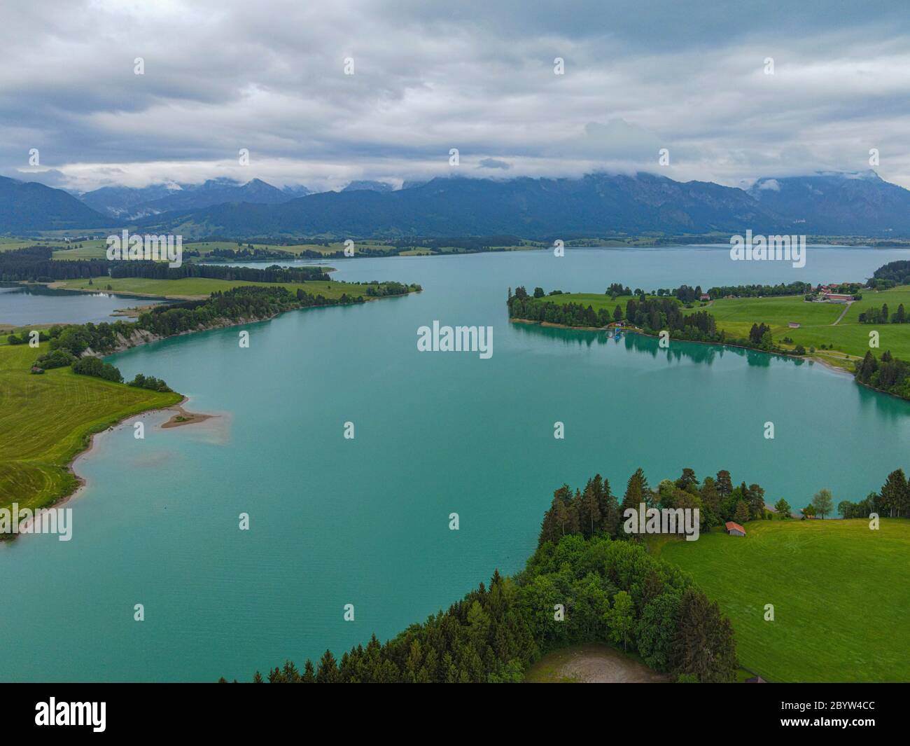 Aerial view over Lake Forggensee at the city of Fuessen in Germany ...